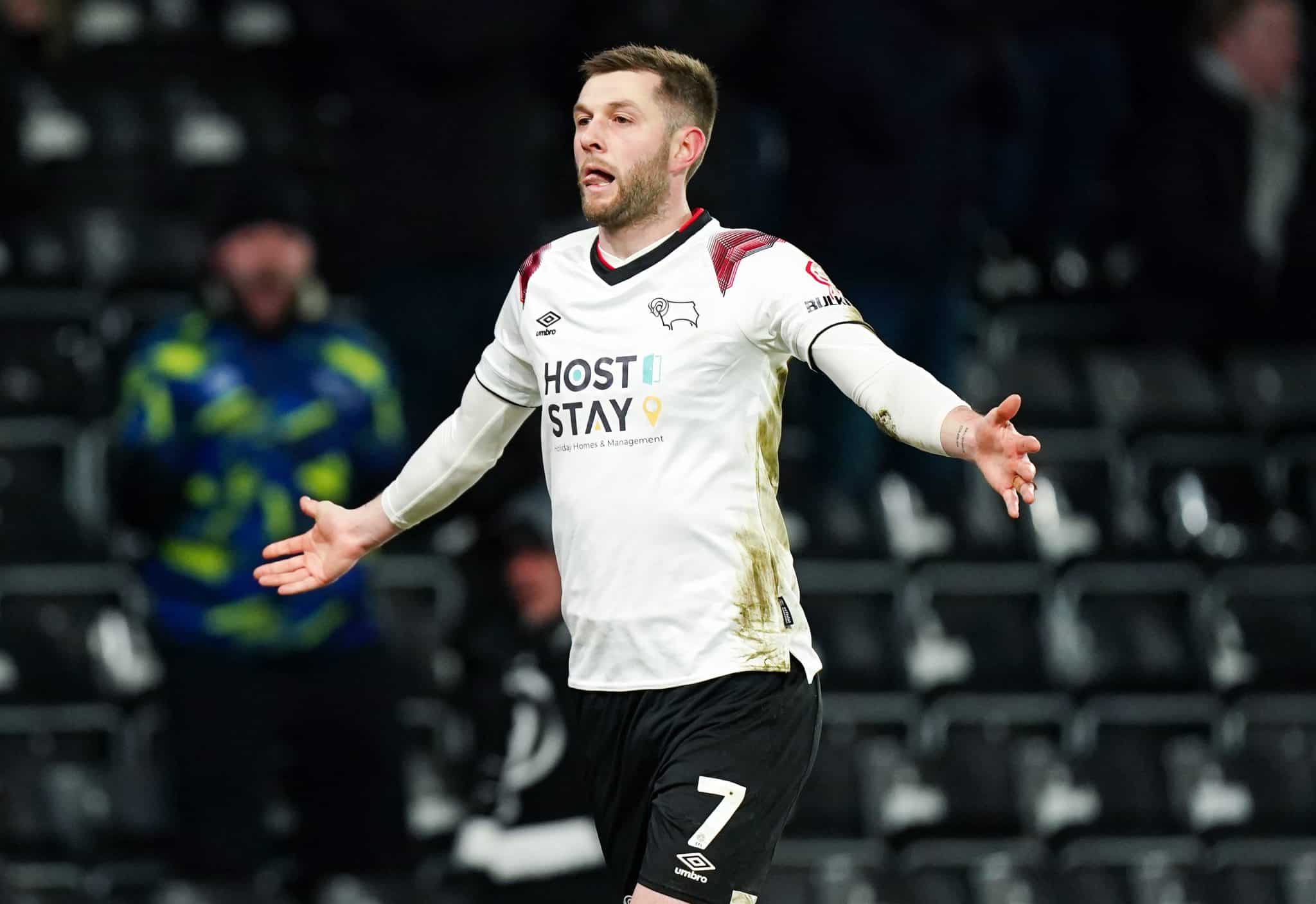 Derby fans on the pitch as they secure promotion back to the Championship